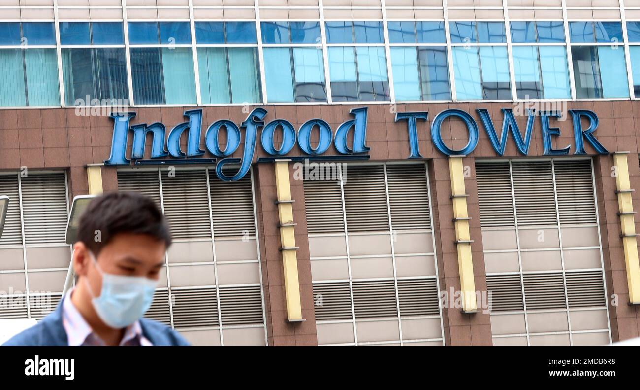 A pedestrian walks past Indofood tower in Jakarta, Indonesia, Monday ...