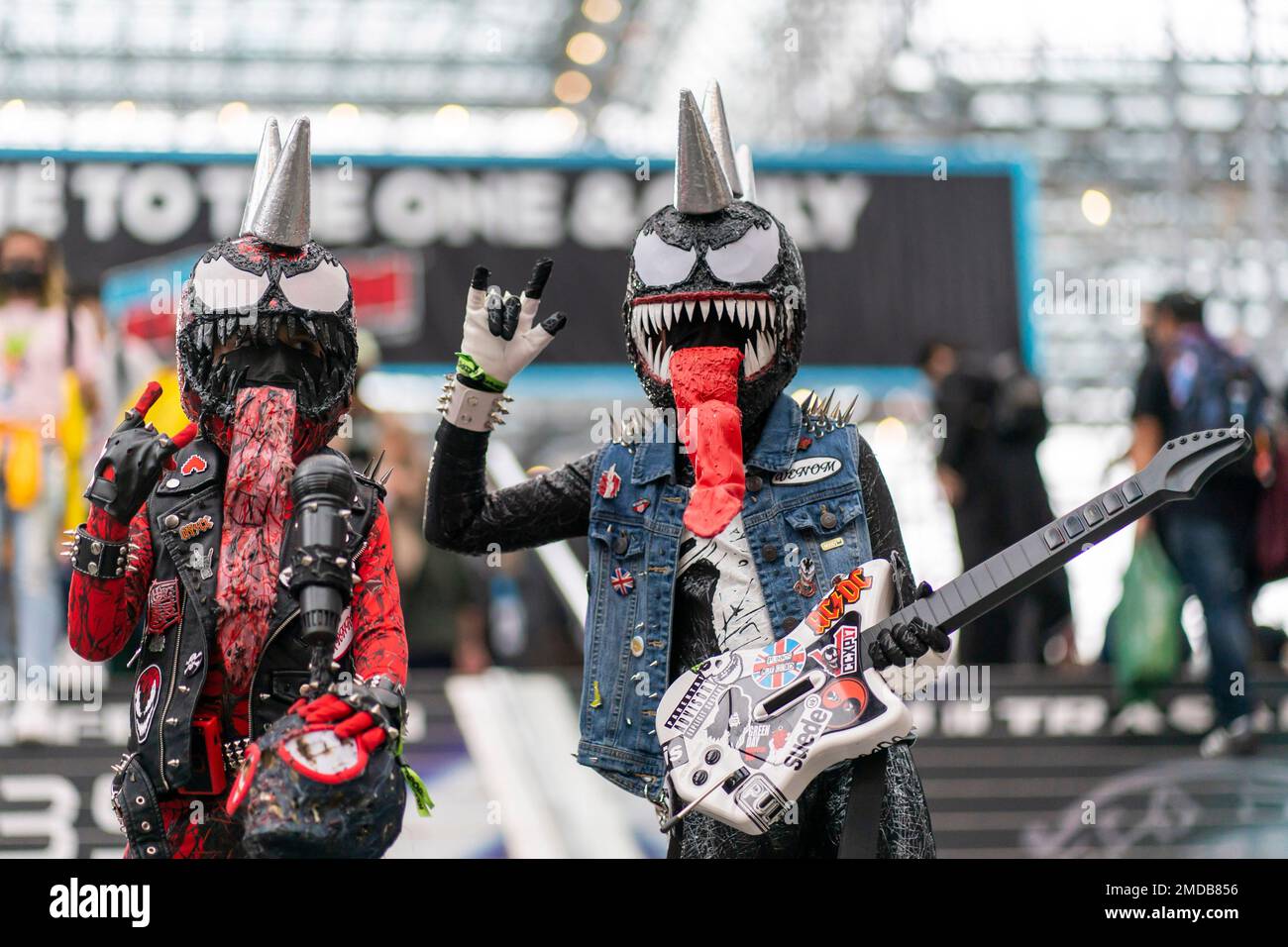 Attendees dressed as Carnage, left, and Venom pose during New York ...