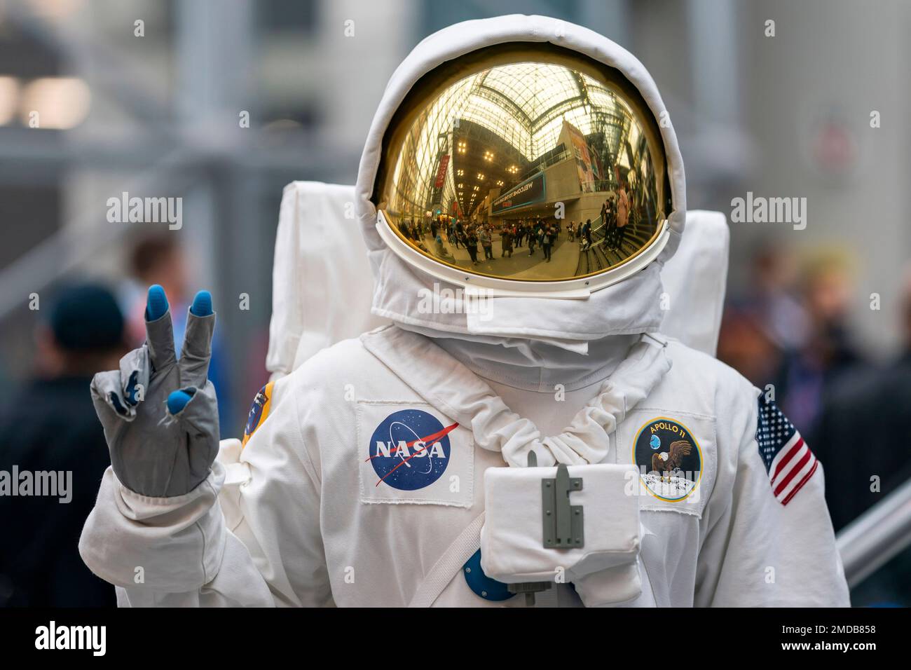 An attendee dressed as an astronaut poses during New York Comic Con at ...