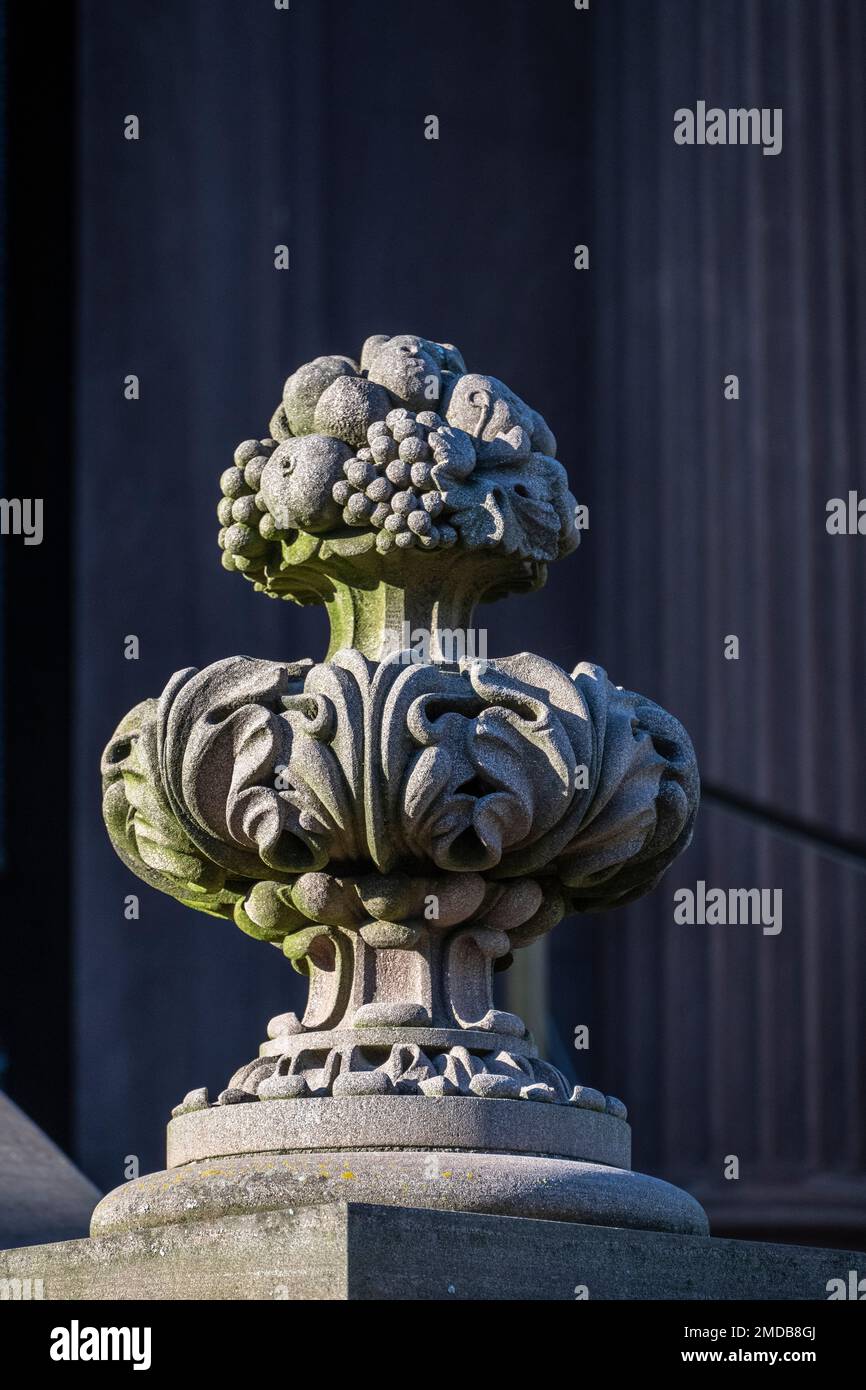 ornated carved post finial in front of Victorian Mansion with fruit on ...