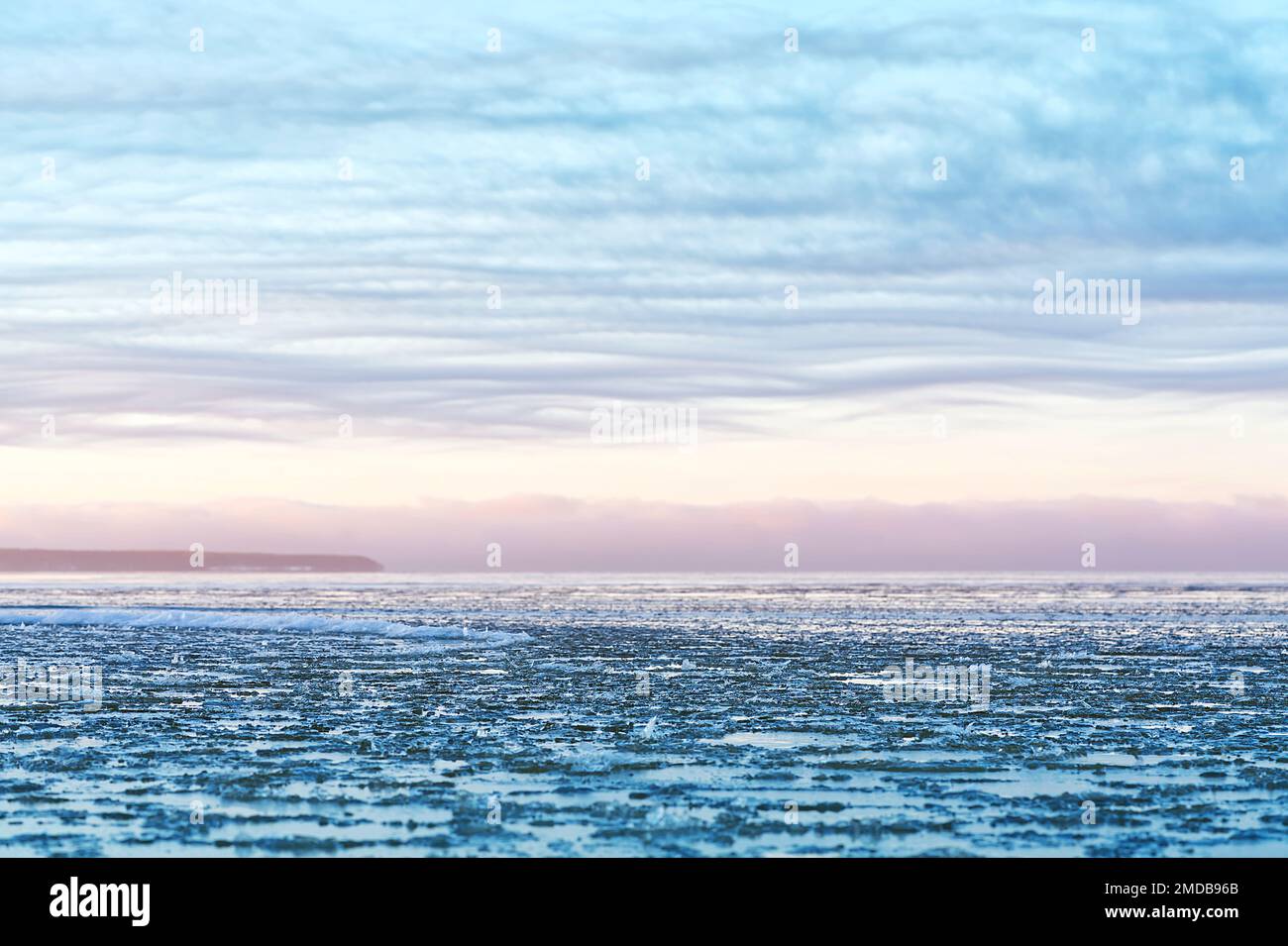 Panoramic view of the snow-covered shore of the Baltic sea at sunset ...