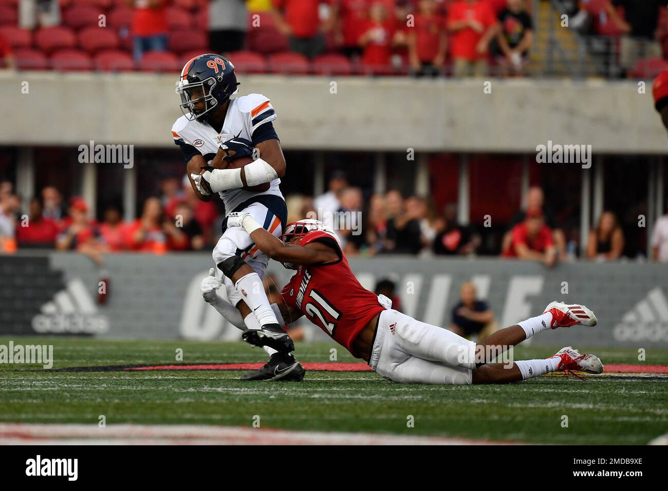 Virginia wide receiver Keytaon Thompson (99) tries to run from the ...