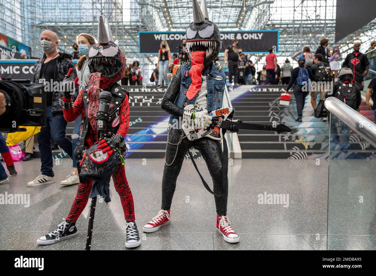 Attendees dressed as Carnage, left, and Venom pose during New York ...