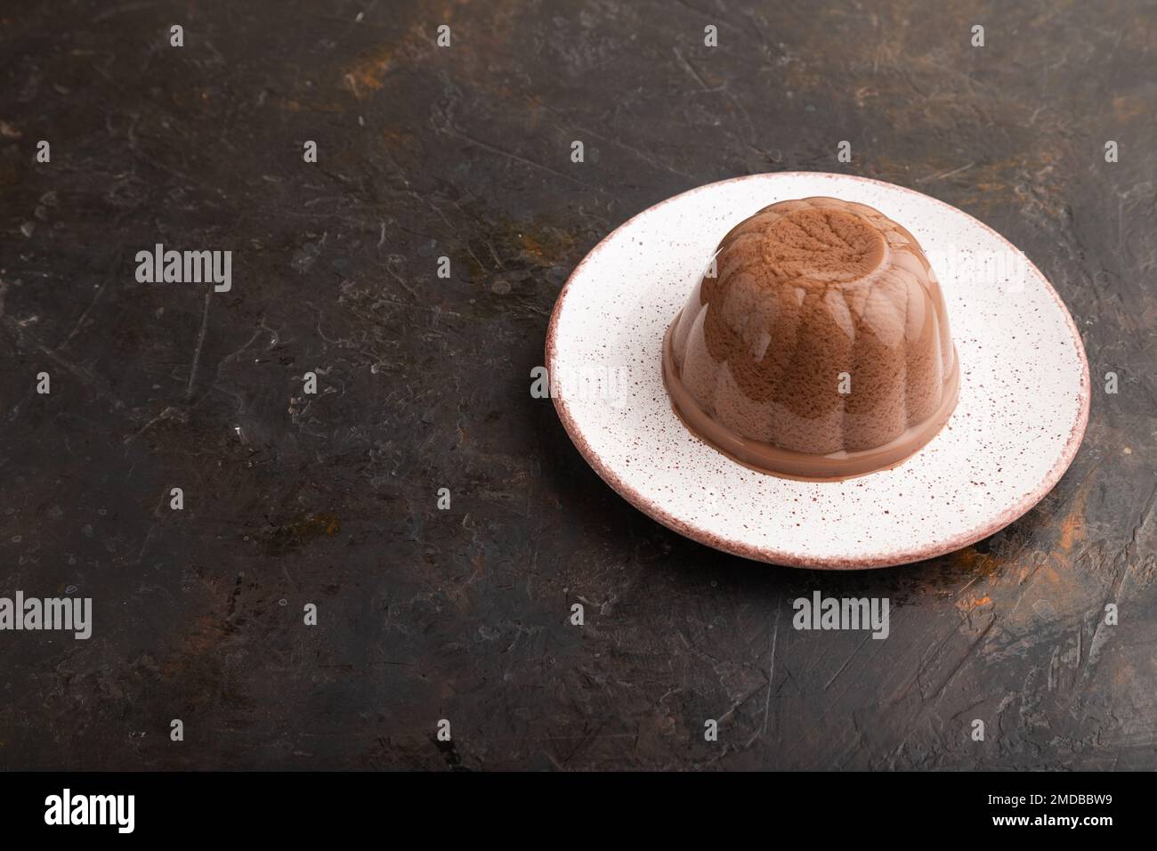 Chocolate jelly on black concrete background. side view, copy space ...