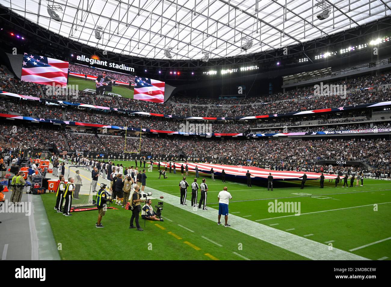 A flag is unfulred before an NFL football game between the Las Vegas ...