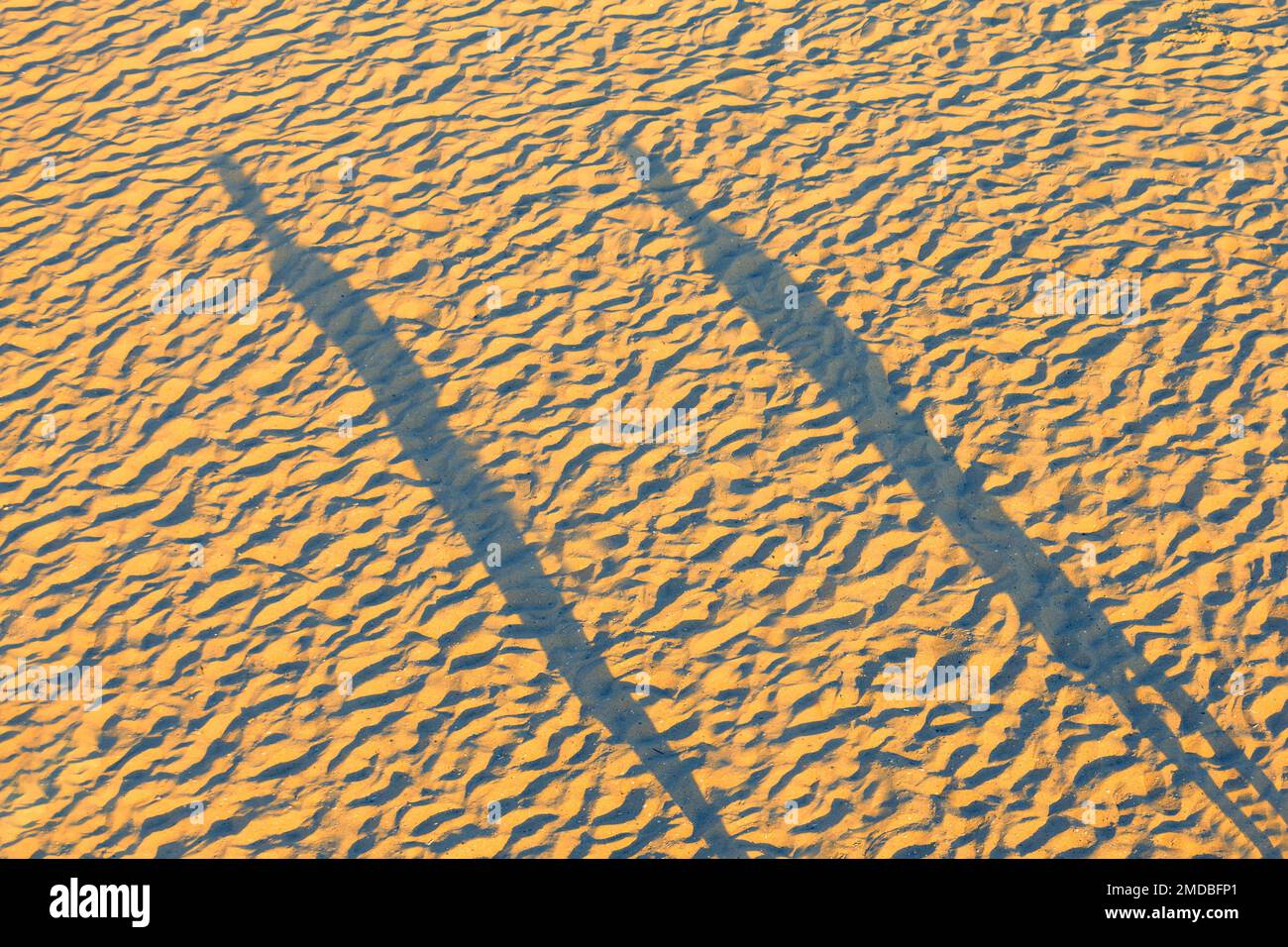 Shadows on the sandy beach . Shadows of two men on the sand Stock Photo ...