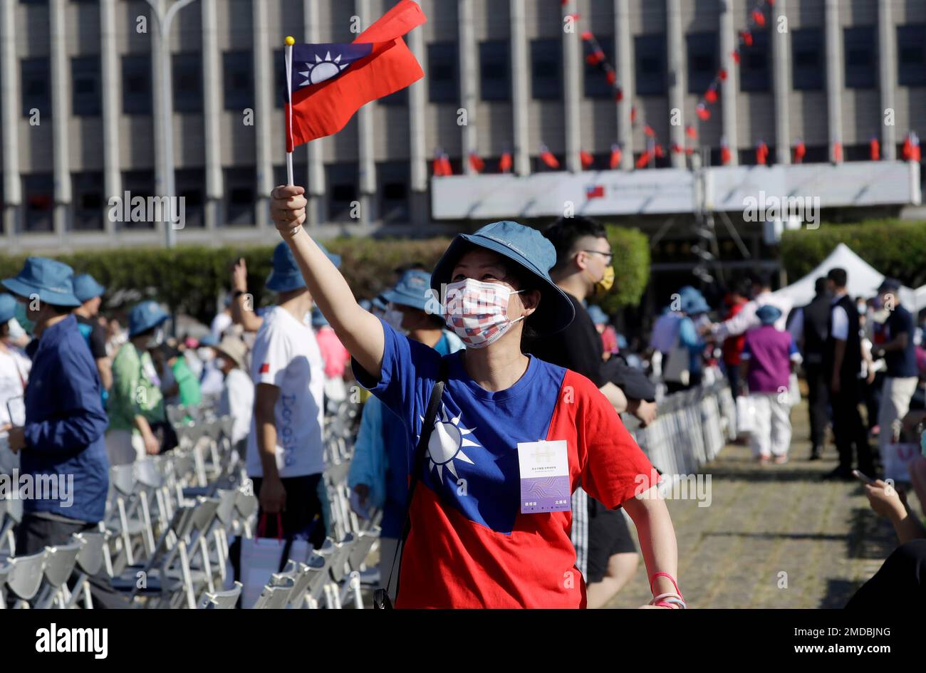 A woman holds and wears Taiwan national flag during National Day ...