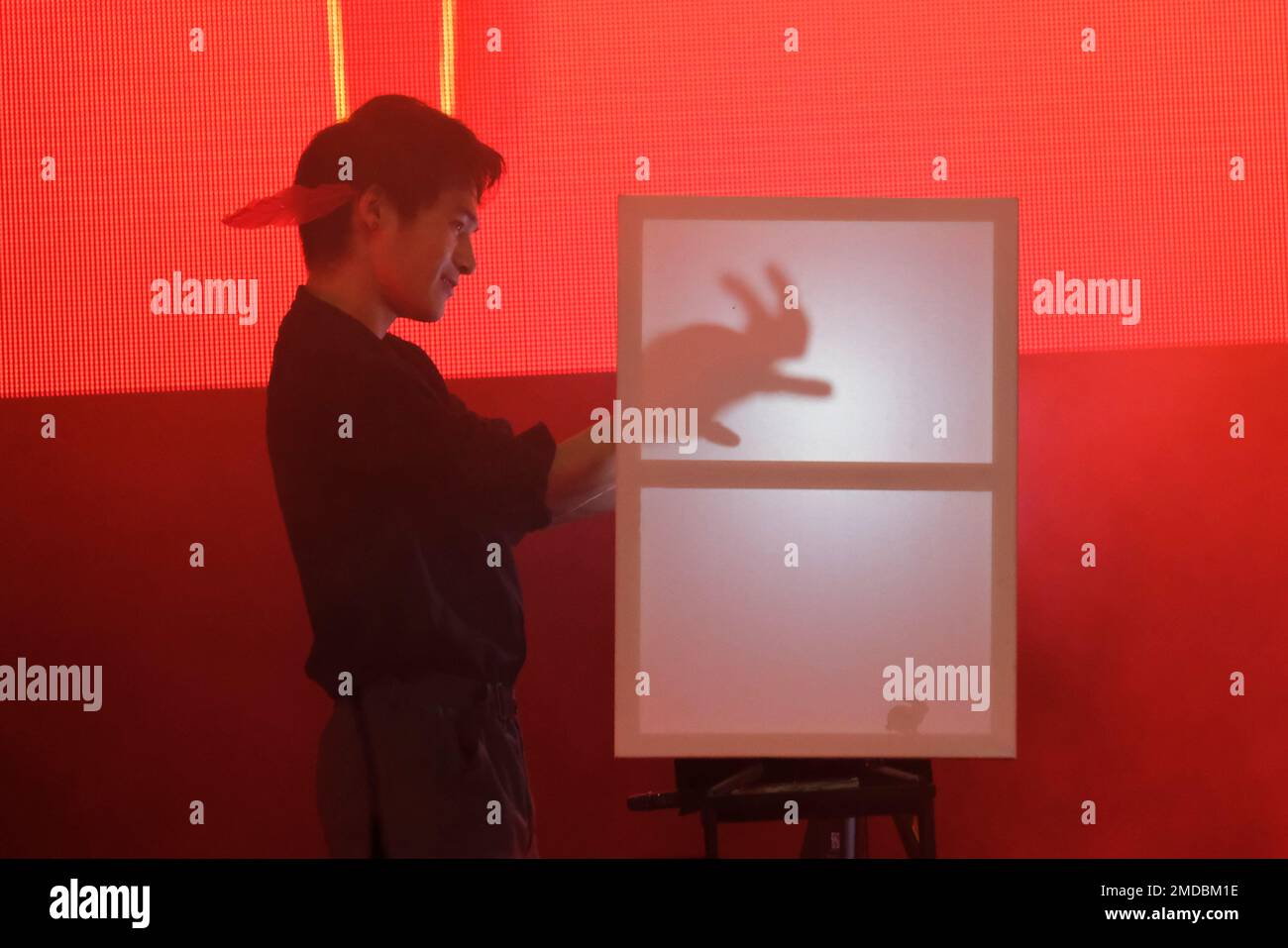 London, UK. 22nd January, 2023. A man creates a rabbit shadow puppet ...