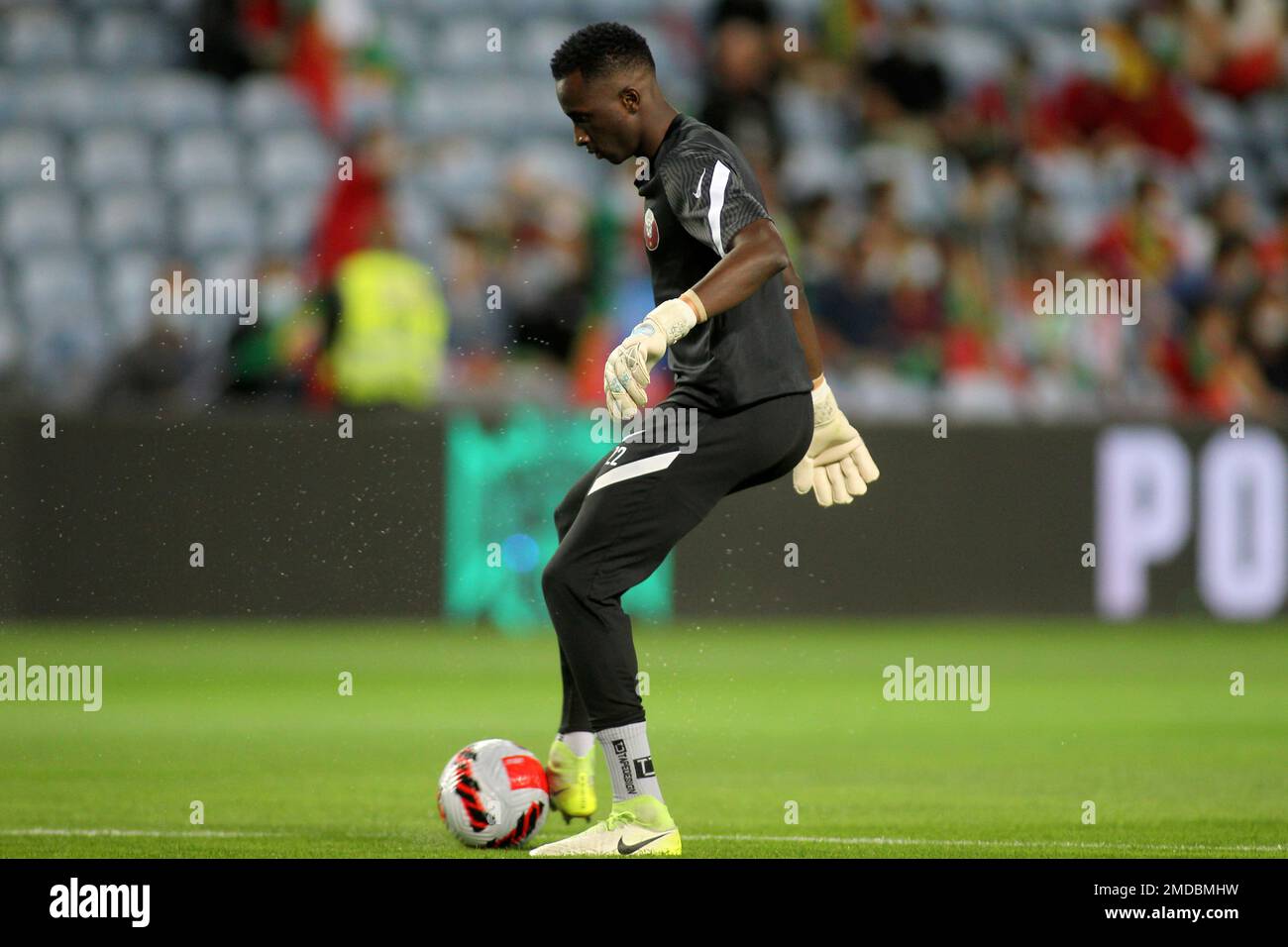 Qatar goalkeeper Meshaal Barsham kicks a ball during warmup before the ...
