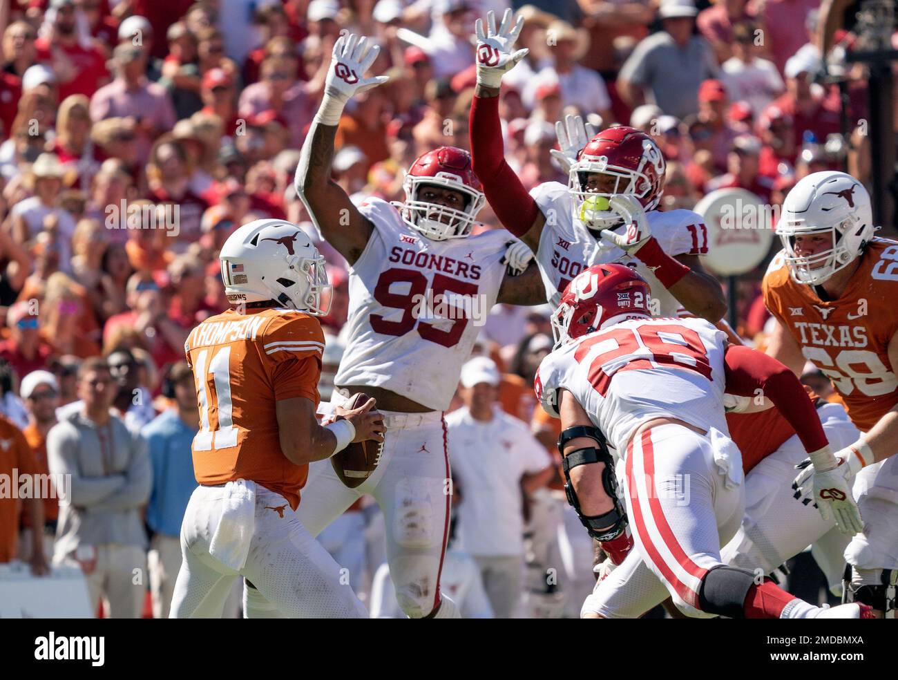 Texas quarterback Casey Thompson (11) has nowhere to go with the ball ...