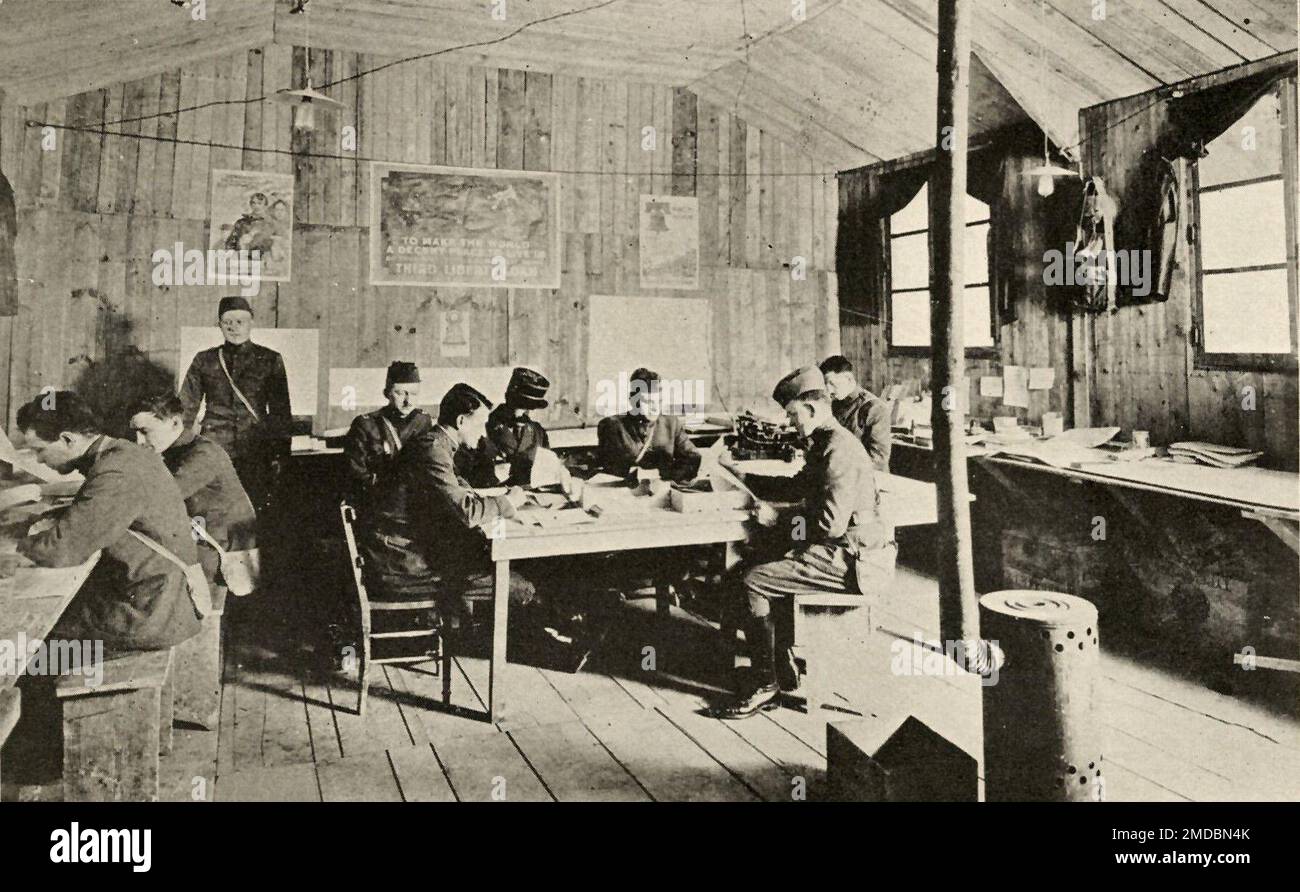 Lt. Col. Samuel Mackall (at table on left) holds a conference with his ...