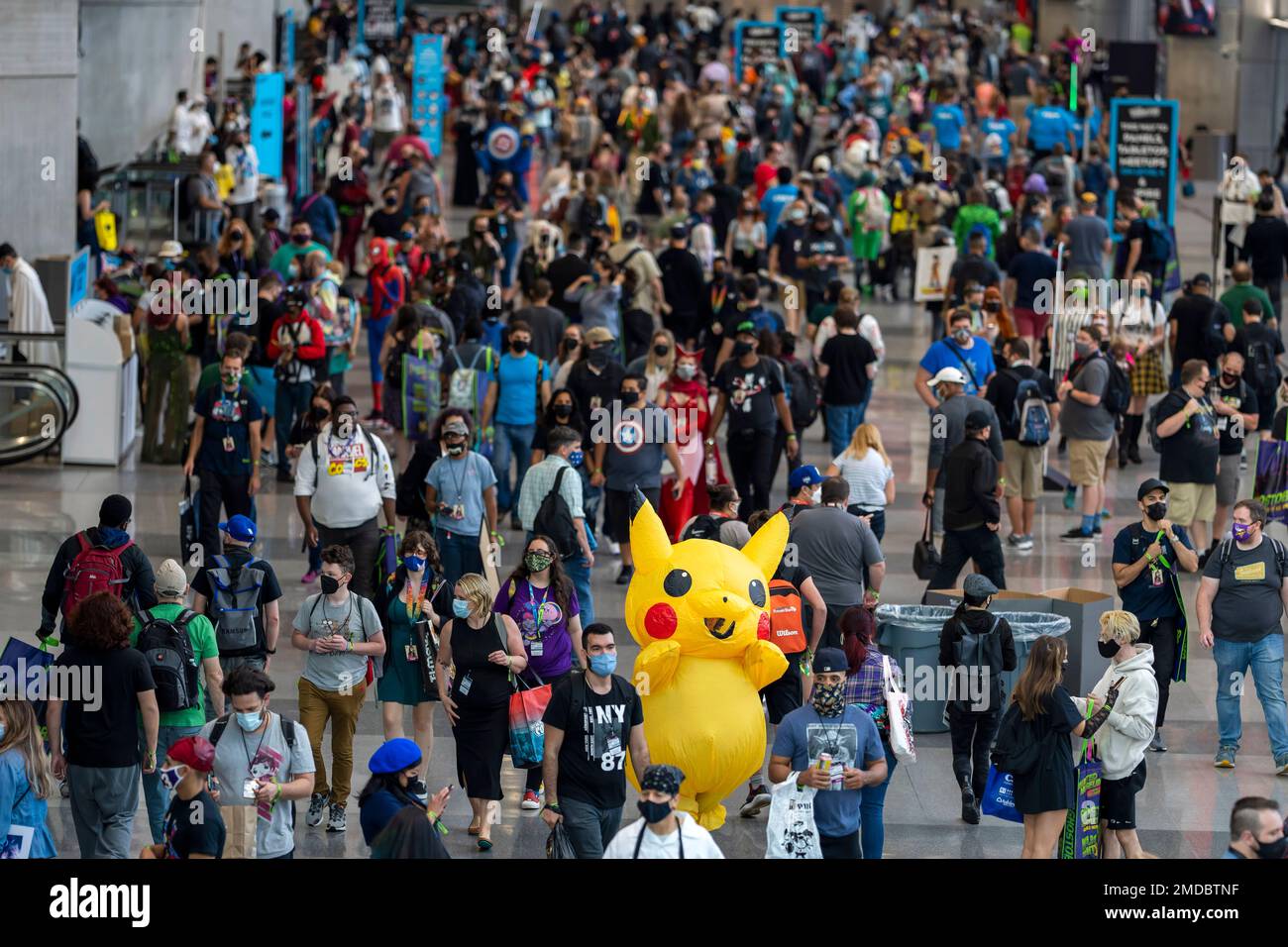 An attendee dressed as the Pikachu Pokemon walks the floor of the Jacob ...