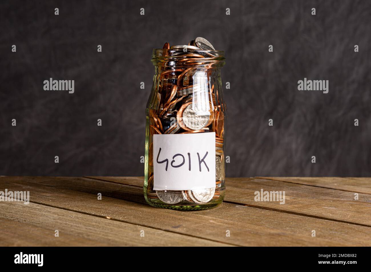 401k savings jar on a dark background Stock Photo - Alamy