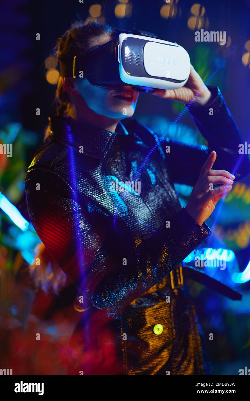 stylish female in metaverse in vr headset pressing the button in the ...