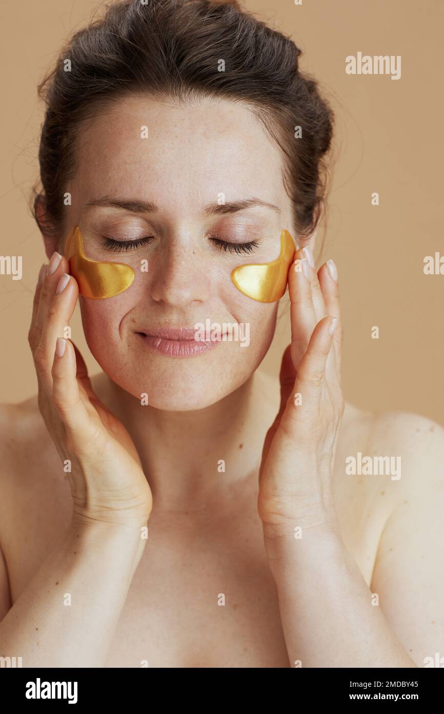 relaxed young woman with eye patches isolated on beige Stock Photo - Alamy