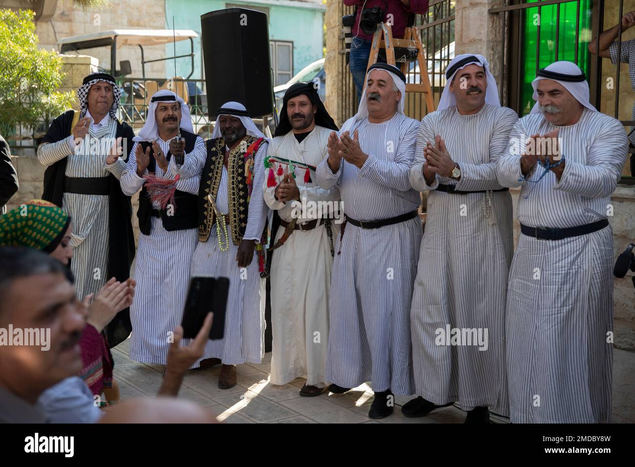 Palestinian men perform Dabke, a traditional popular folk dance, during ...