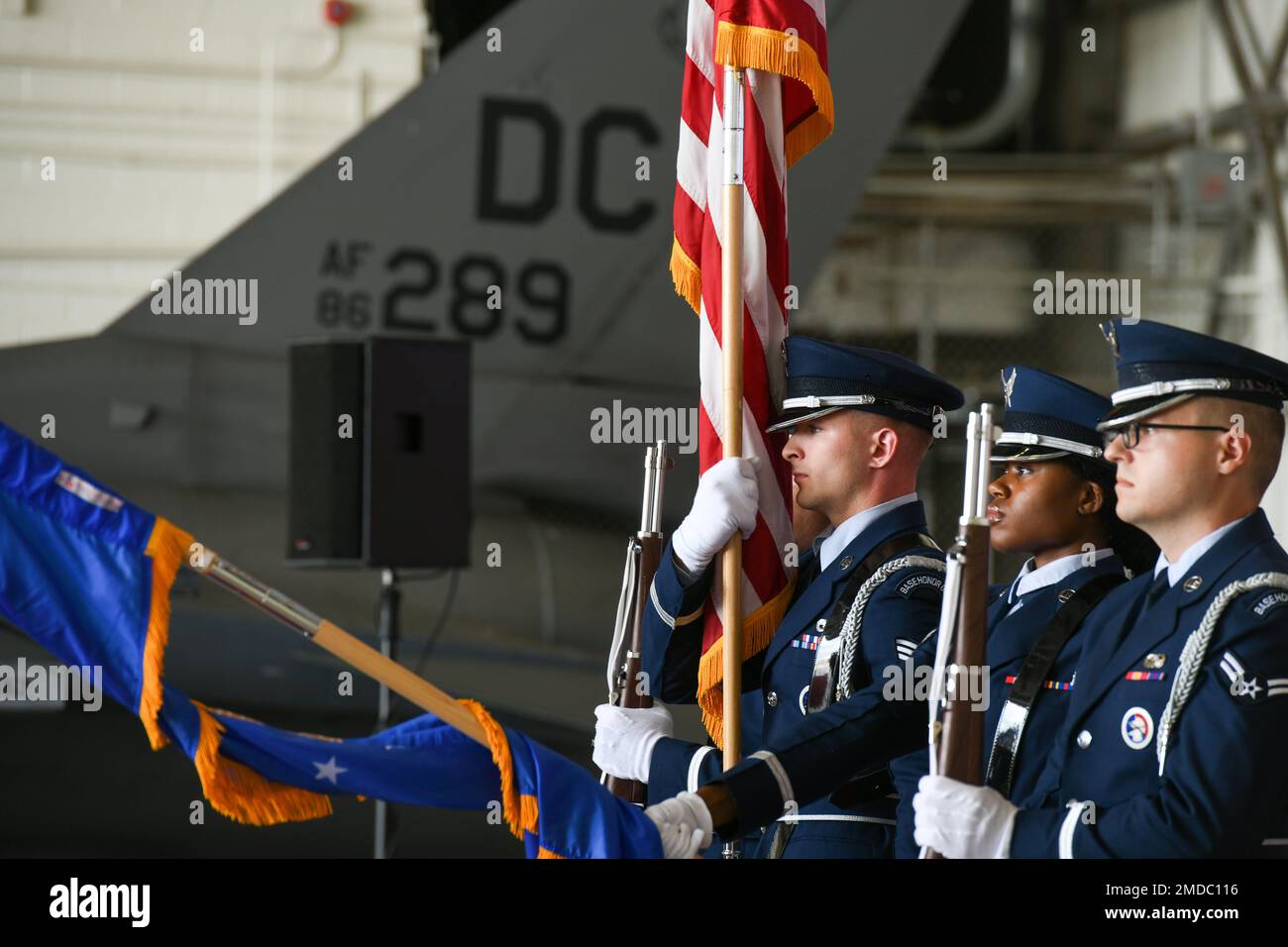 Members of the Base Honor Guard present the U.S. and Air Force colors ...