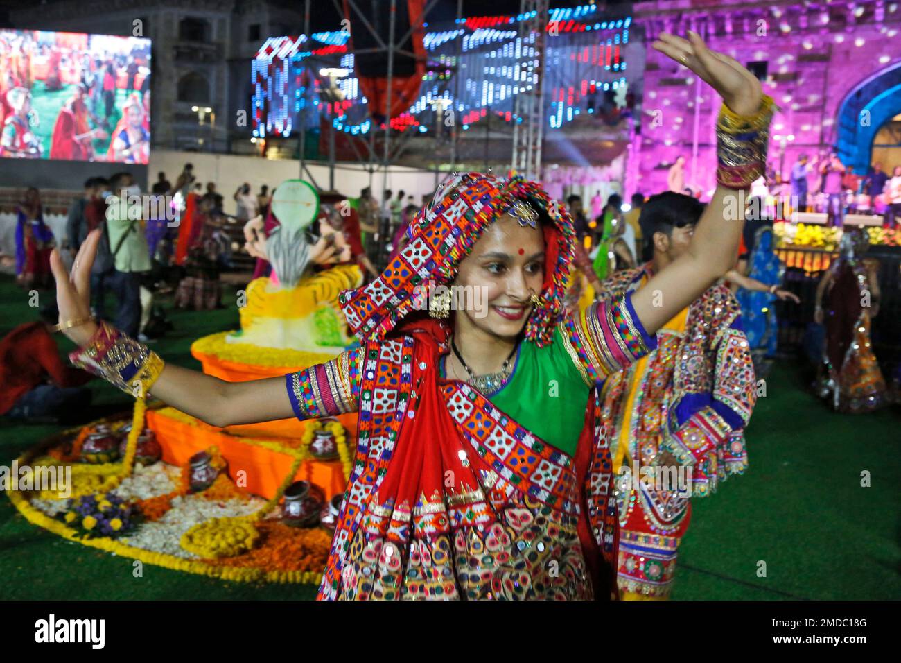 Indians wearing traditional attire perform the Garba, a dance of ...