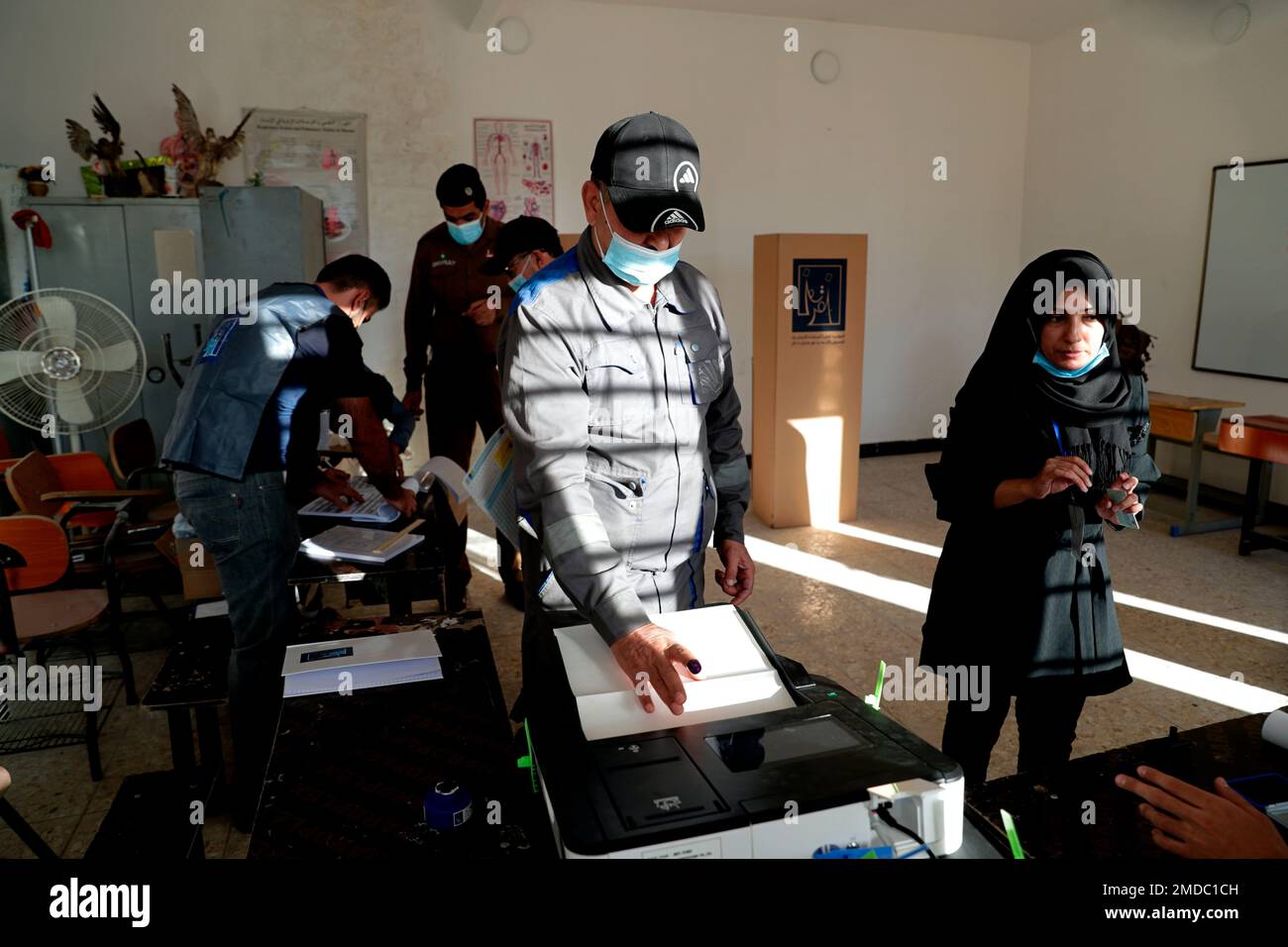 An Iraqi soldier casts his vote at a polling center ahead of Iraq's ...