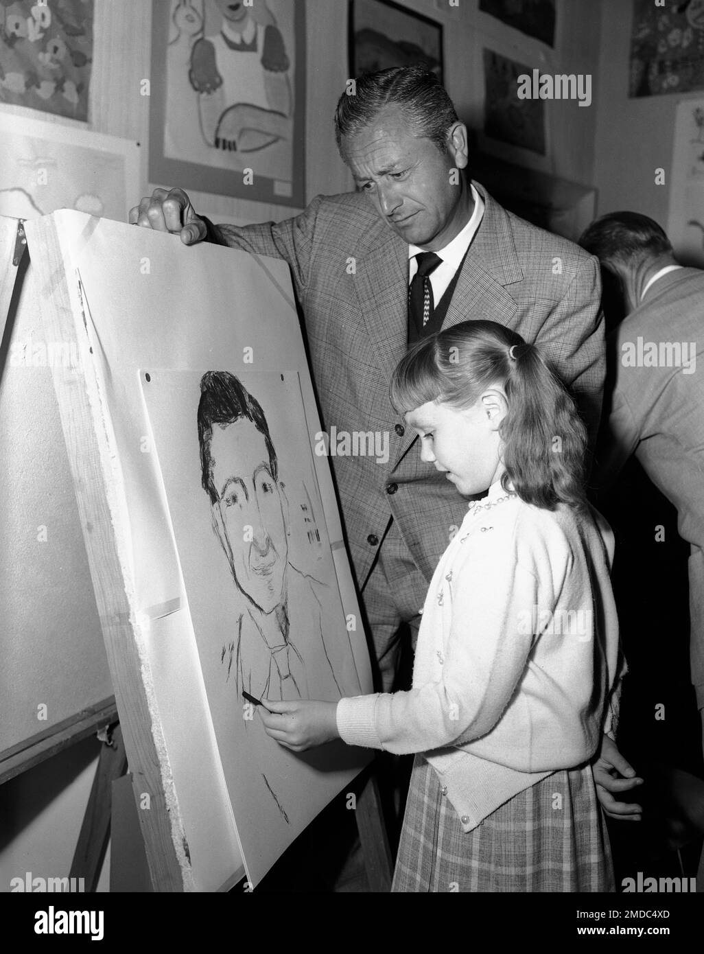 Actor Robert Young looks on as his 7-year-old daughter Kathy makes a ...