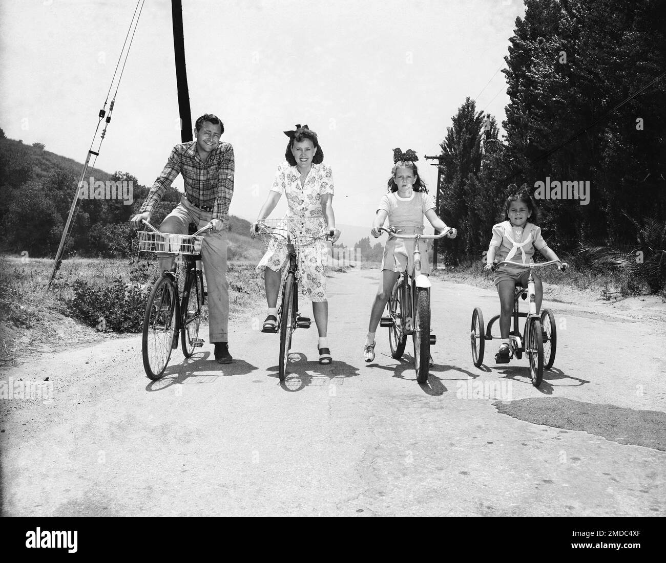 Screen actor Robert Young and his family ride bikes in the country near ...