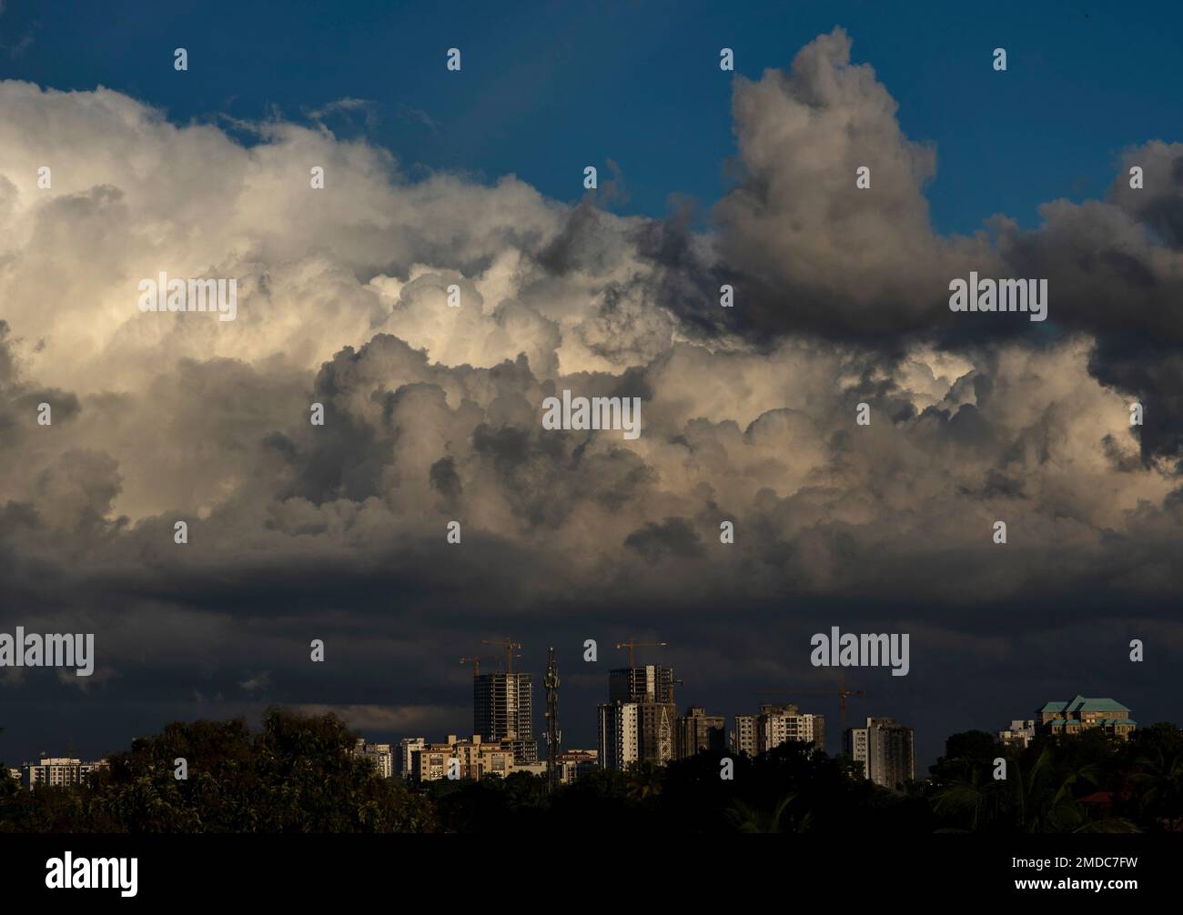 Clouds gather above high-rise buildings under construction that are ...
