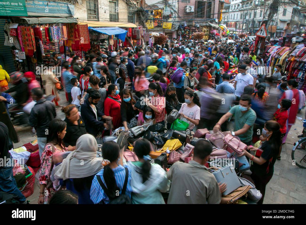 Nepalese people crowd a market as they shop on the first day of Dashain festival in Kathmandu ...