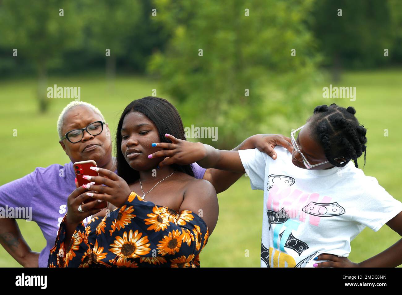 Zakia Buchanan, center, shows TikTok videos to her mom, Delicia Harris ...