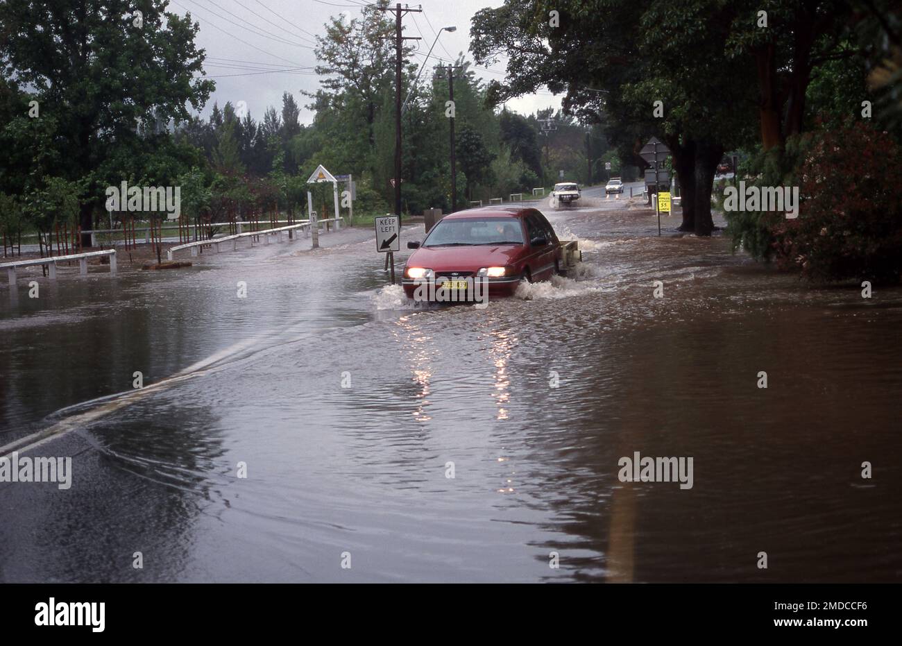 VEHICLES DRIVING THROUGH FLOOD WATERS, NEW SOUTH WALES, AUSTRALIA Stock ...