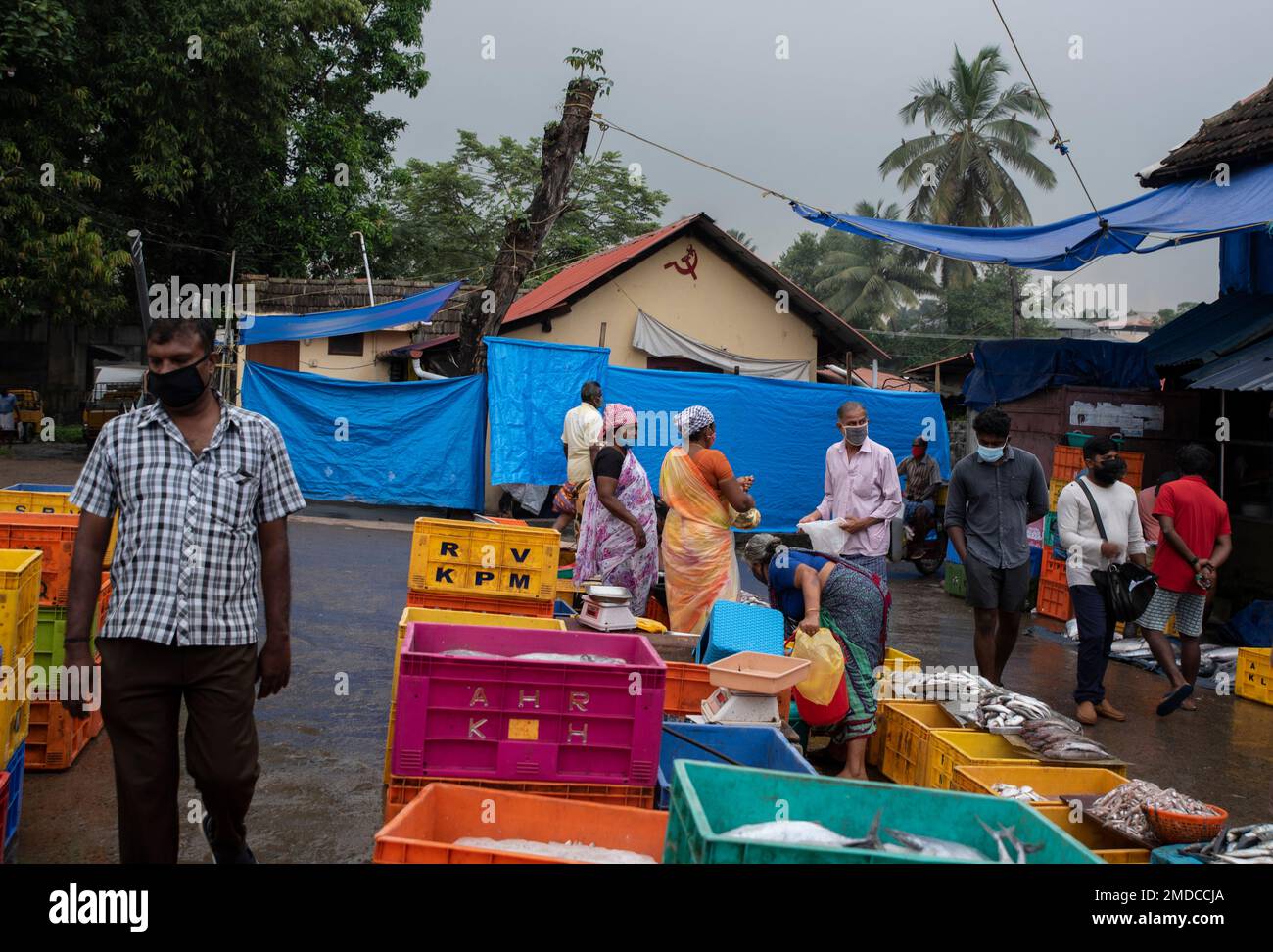 A man, center right, wearing mask as a precaution against the ...