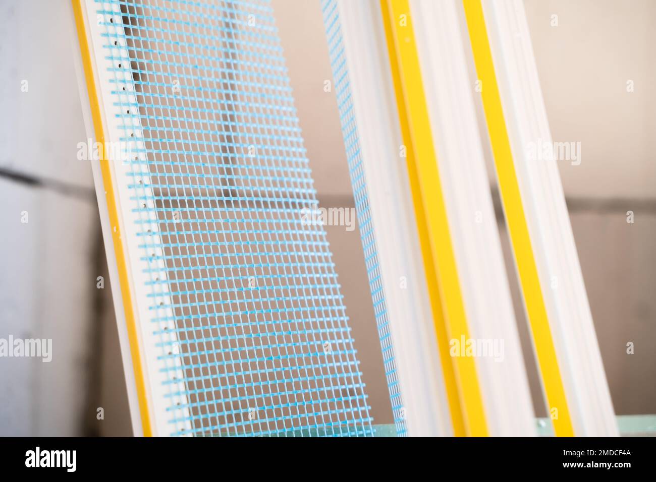 PVC window profile with a cuff and a blue mesh close-up on a blurred ...