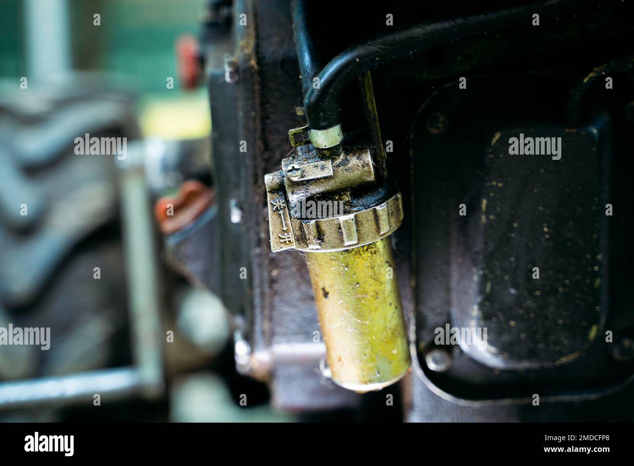 Filter for diesel fuel on the body of a walk-behind tractor close-up ...