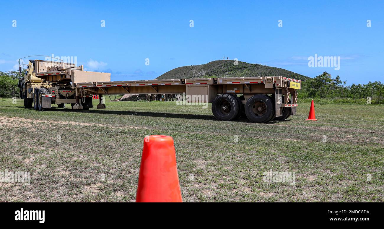 A U.S. Soldier maneuvers a heavy equipment transporter through a ...