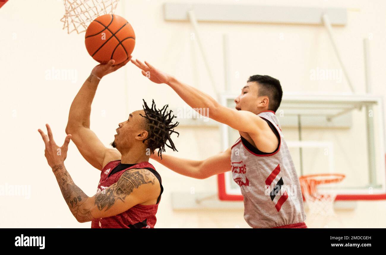 Trey McGowens, left, takes a shot against Keisei Tominaga during the ...