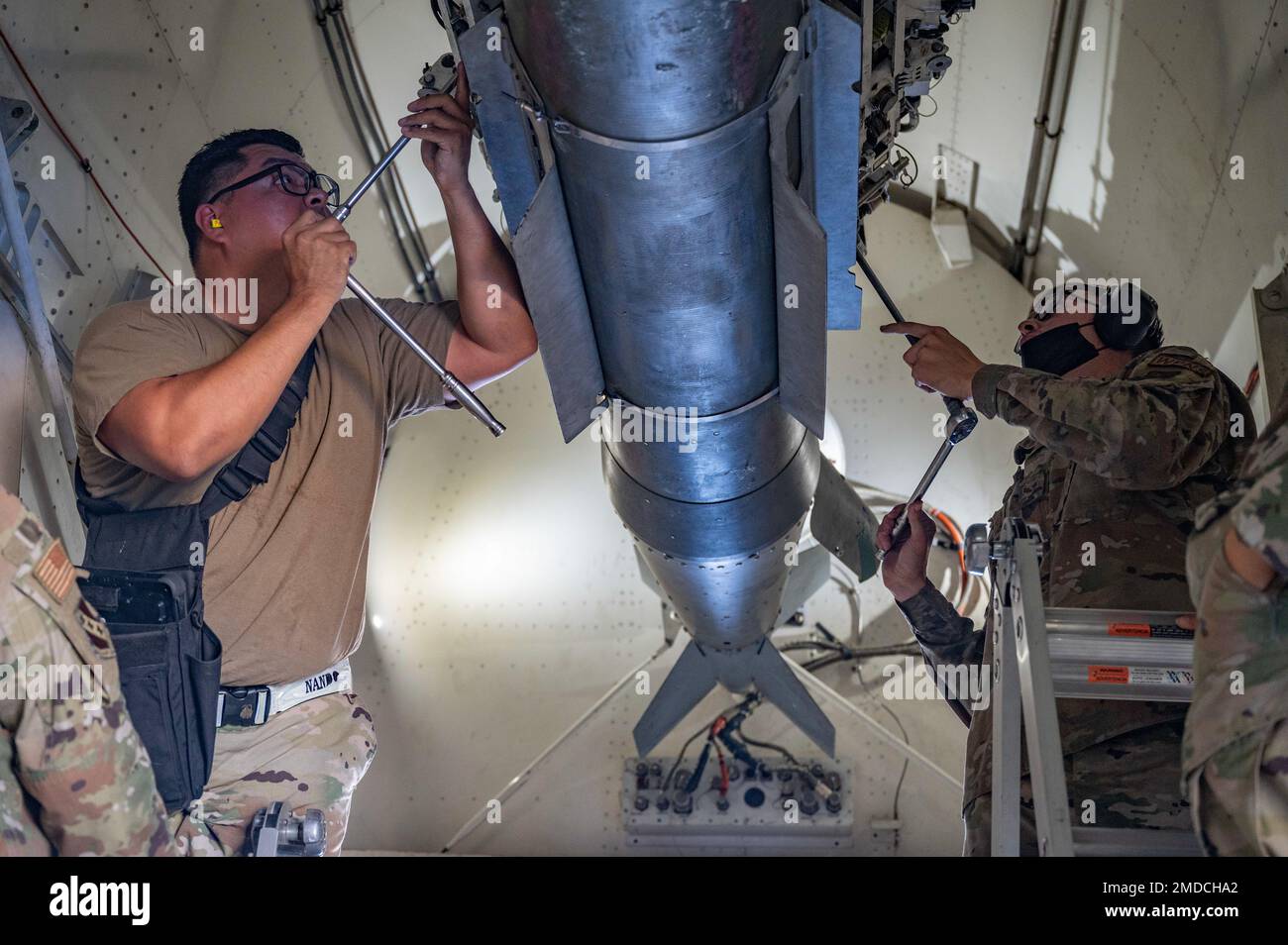 Weapons load crew members assigned to the 9th Aircraft Maintenance Unit ...