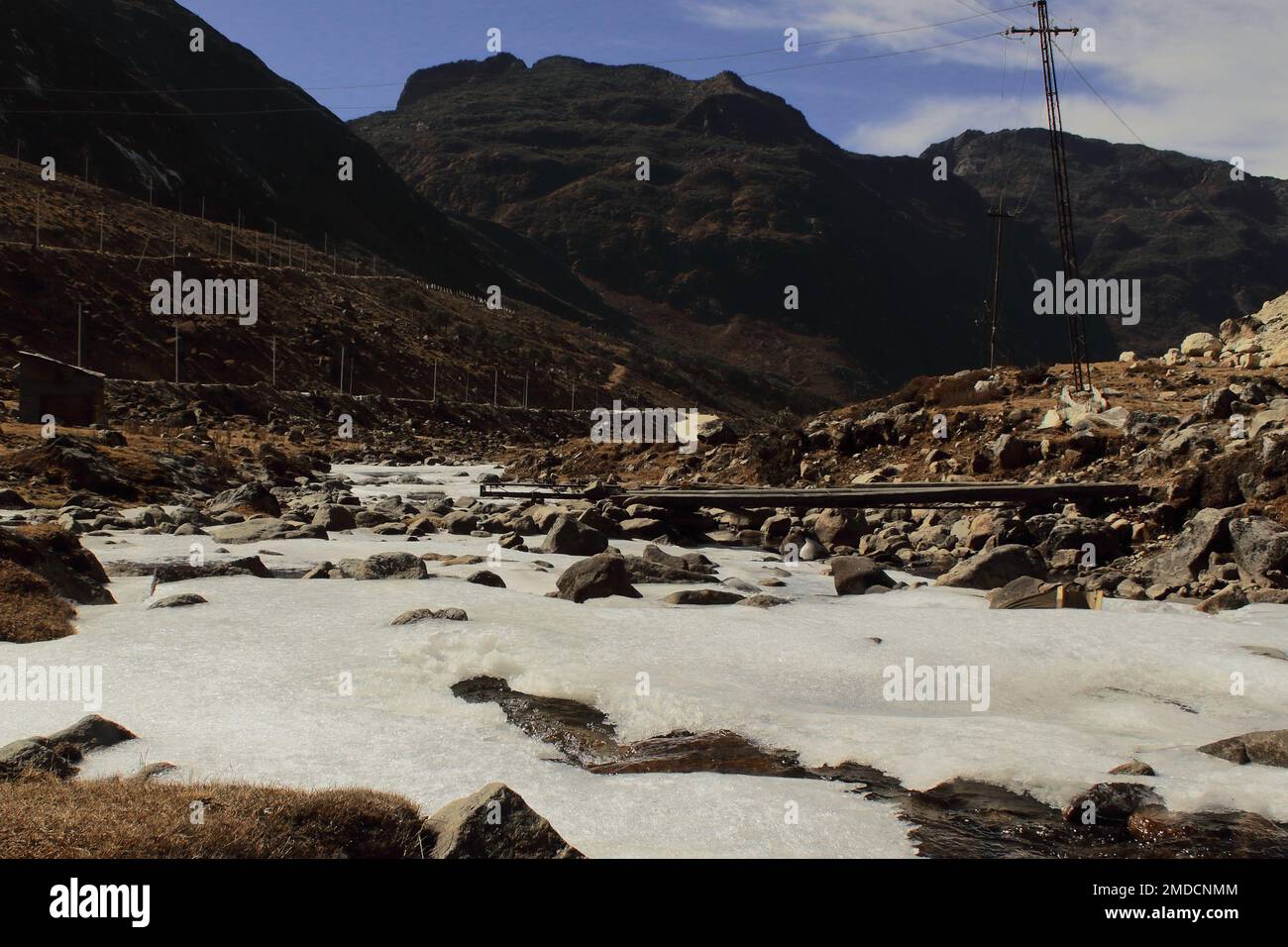 frozen mountain stream near sela pass, high himalayan pass is located ...