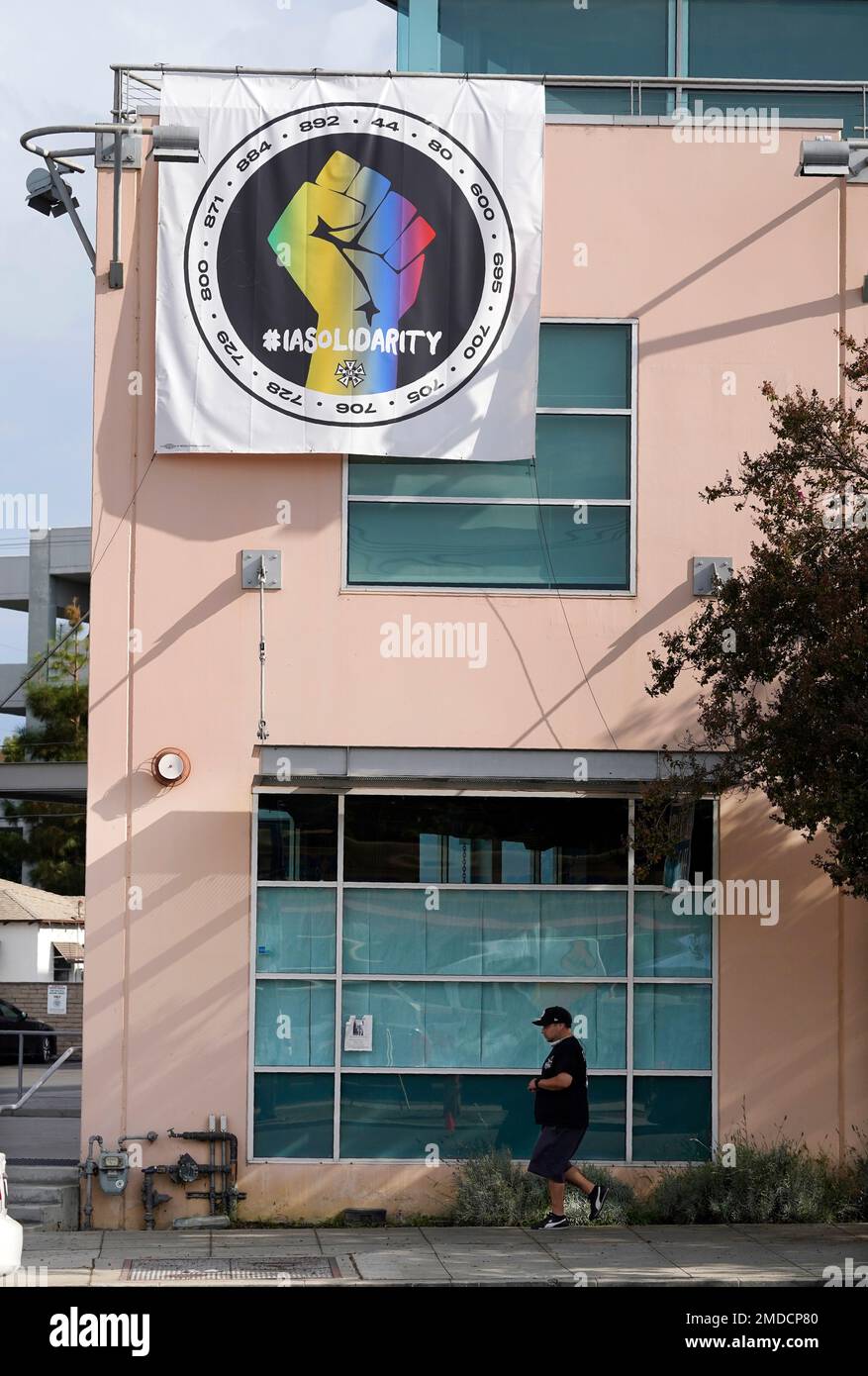 A man walks underneath a poster advocating union solidarity at the ...
