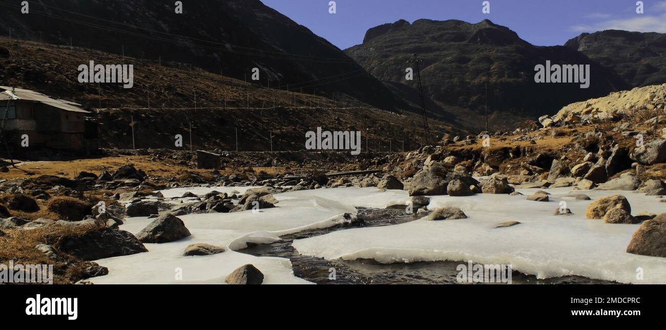 frozen mountain stream near sela pass, high himalayan pass is located ...