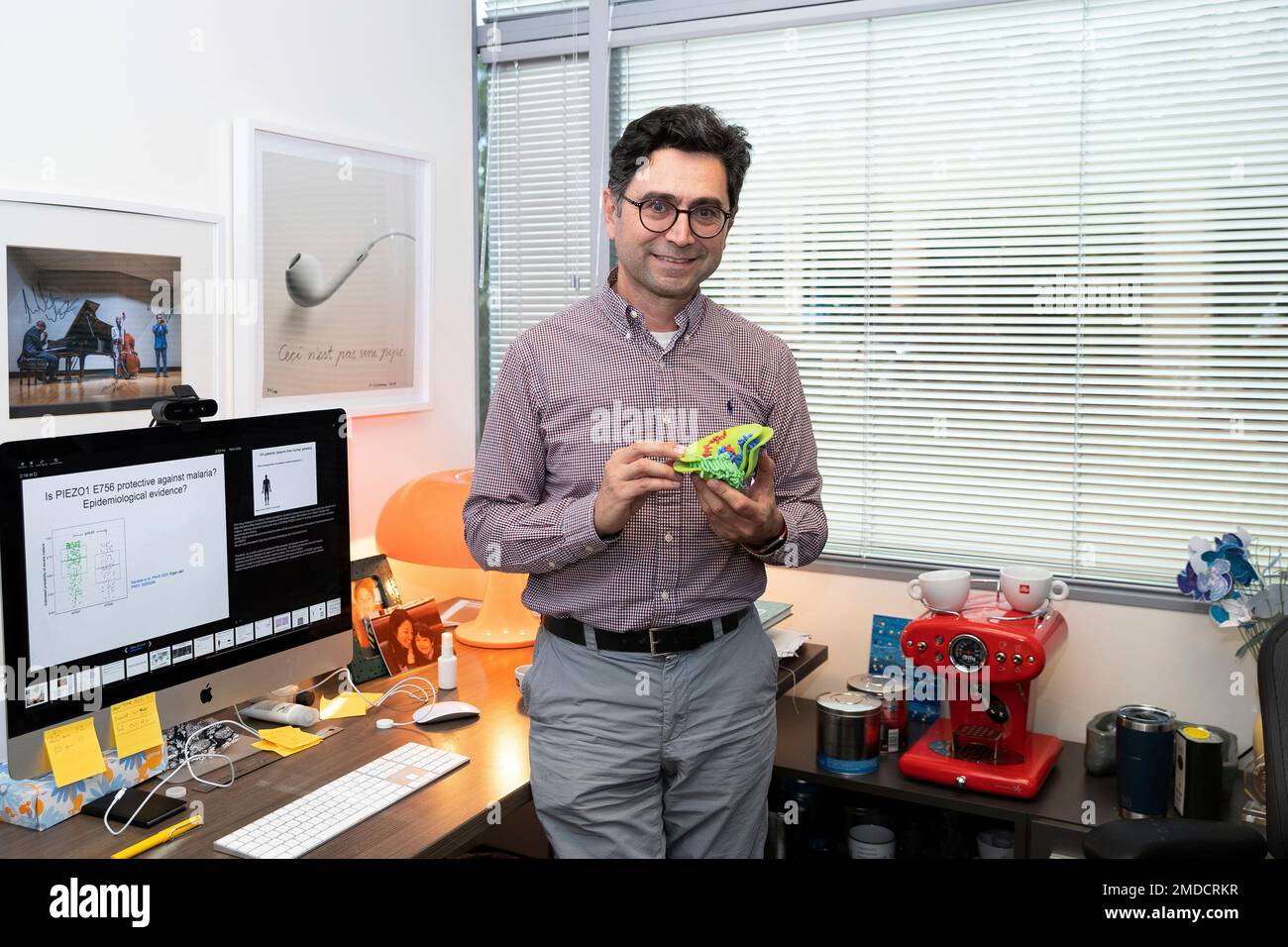 Ardem Patapoutian poses for a portrait in his office while holding a ...