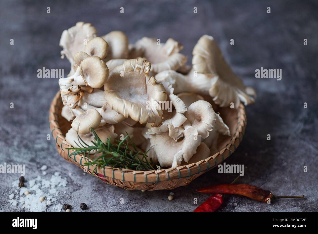 Grey oyster mushroom on basket , fresh raw oyster mushroom with herbs ...