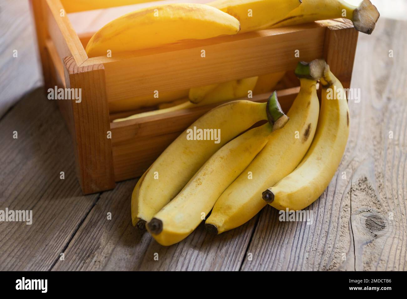 banana on wooden box background, ripe banana fruit on floor - bunch of ...