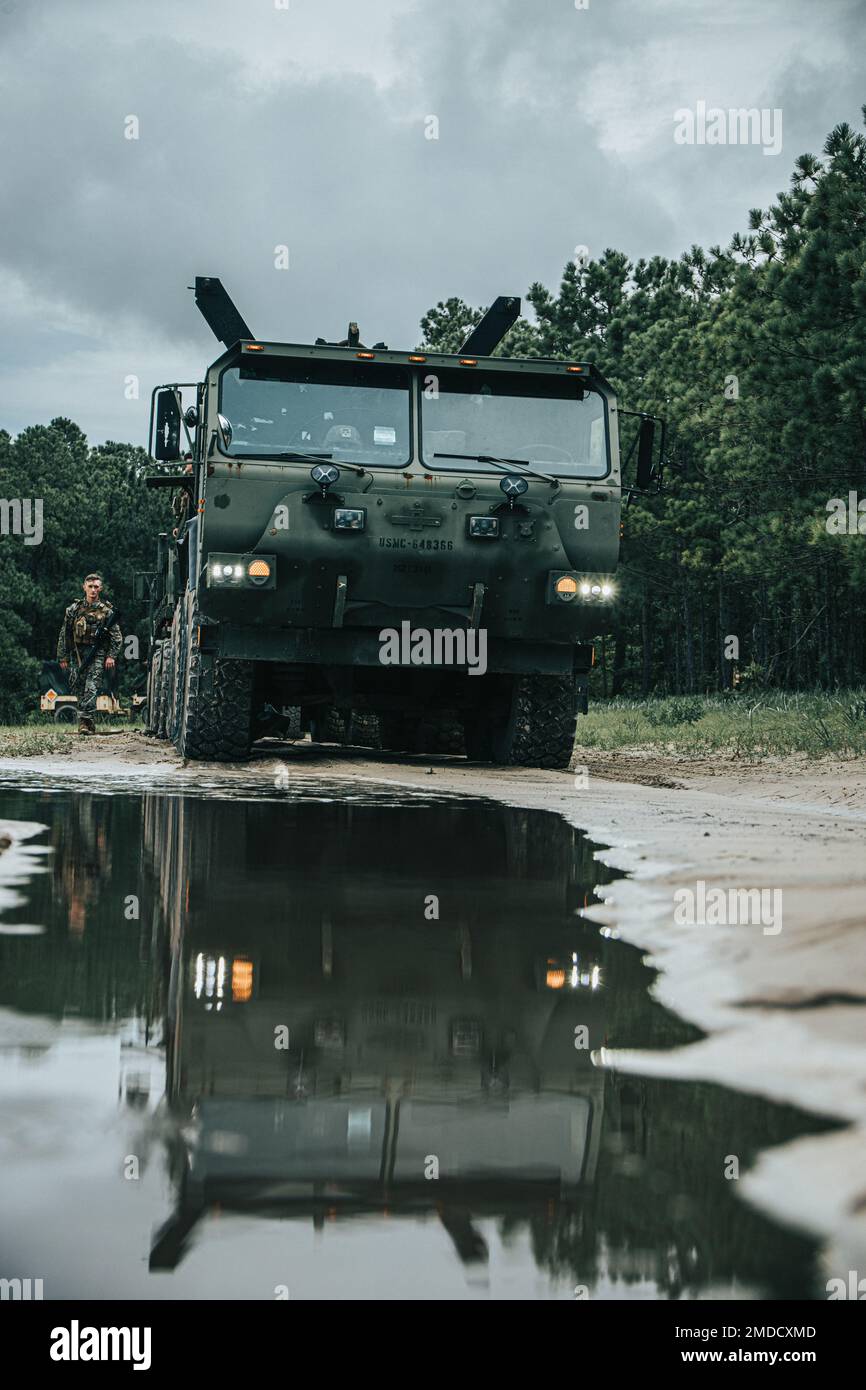 A heavy expanded mobility tactical truck carries a 420E backhoe loader ...