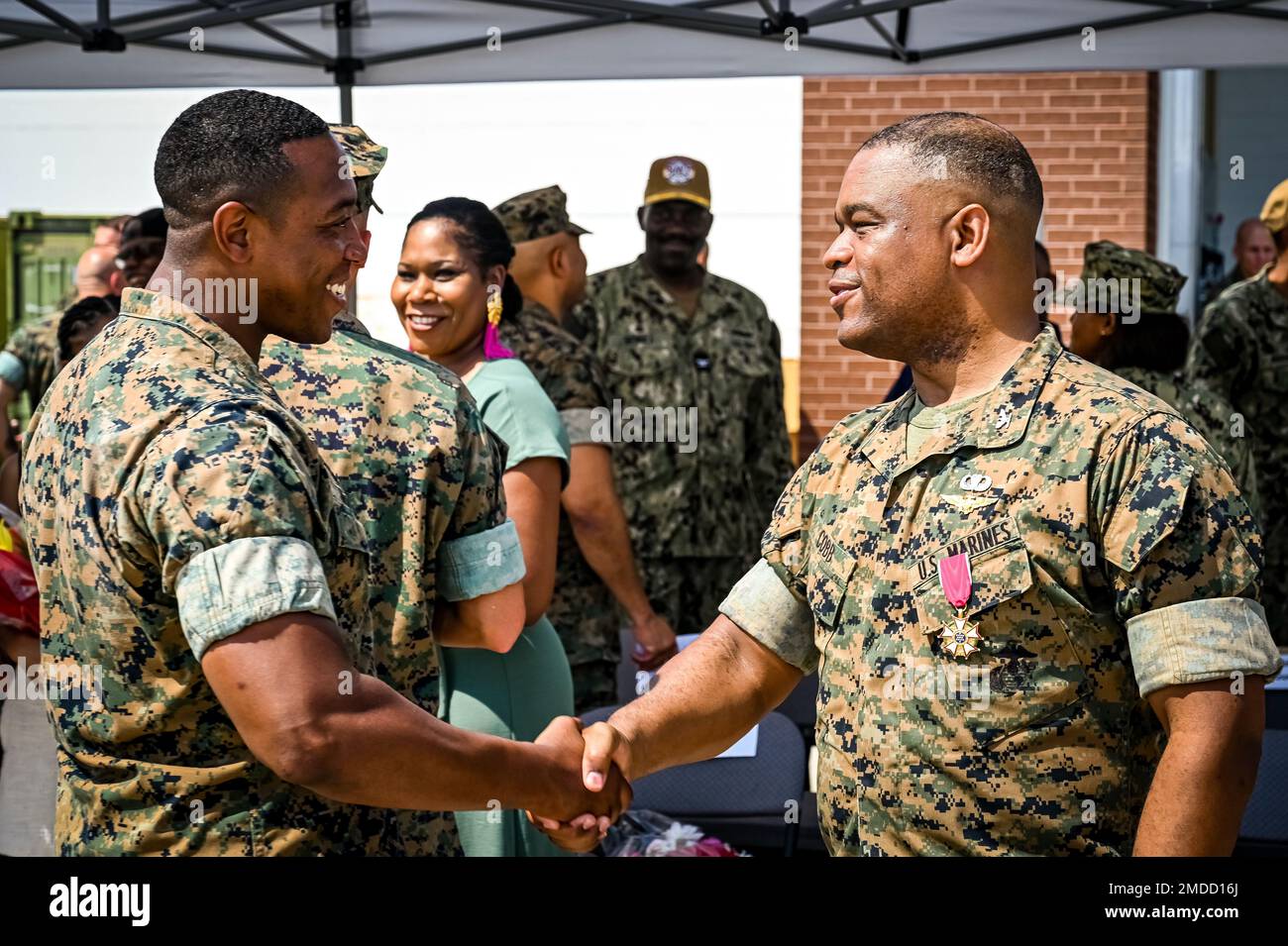 A U.S. Marine assigned to Marine Aircraft Group 49 shakes the hand of U ...