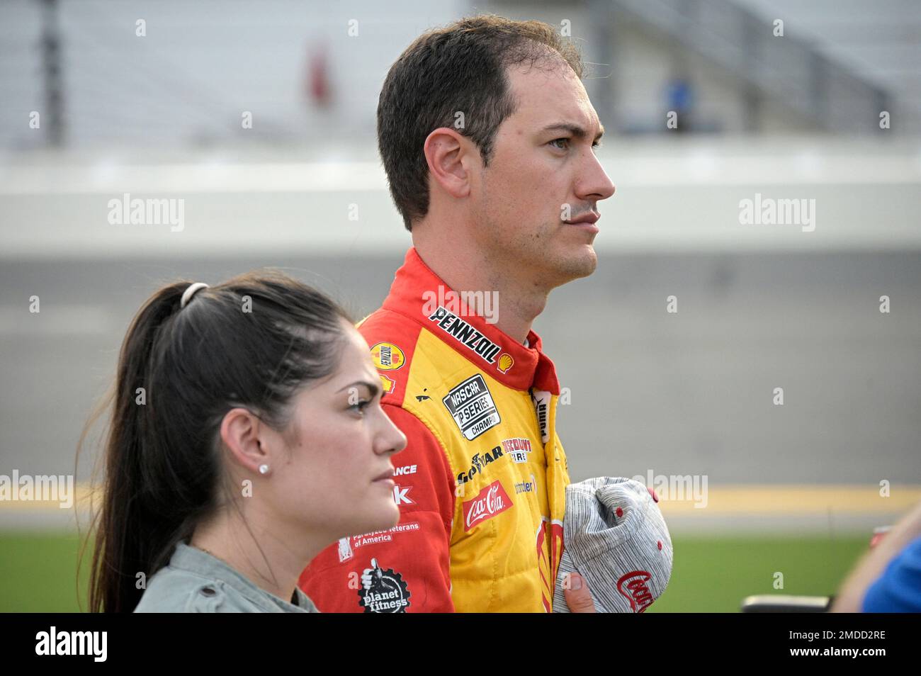 Driver Joey Logano, right, stands next to his vehicle with his wife ...