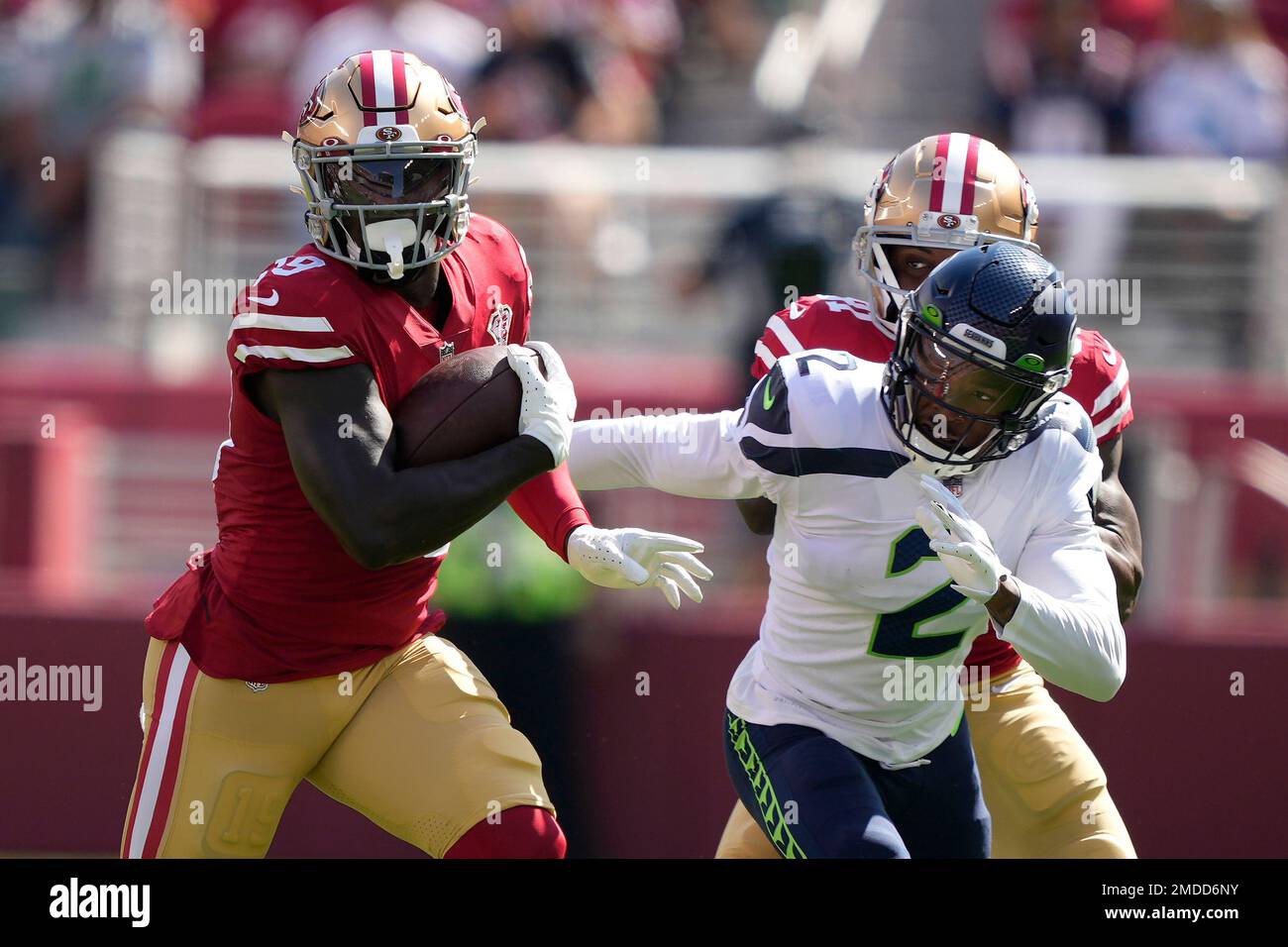 San Francisco 49ers wide receiver Deebo Samuel, left, runs in front of ...