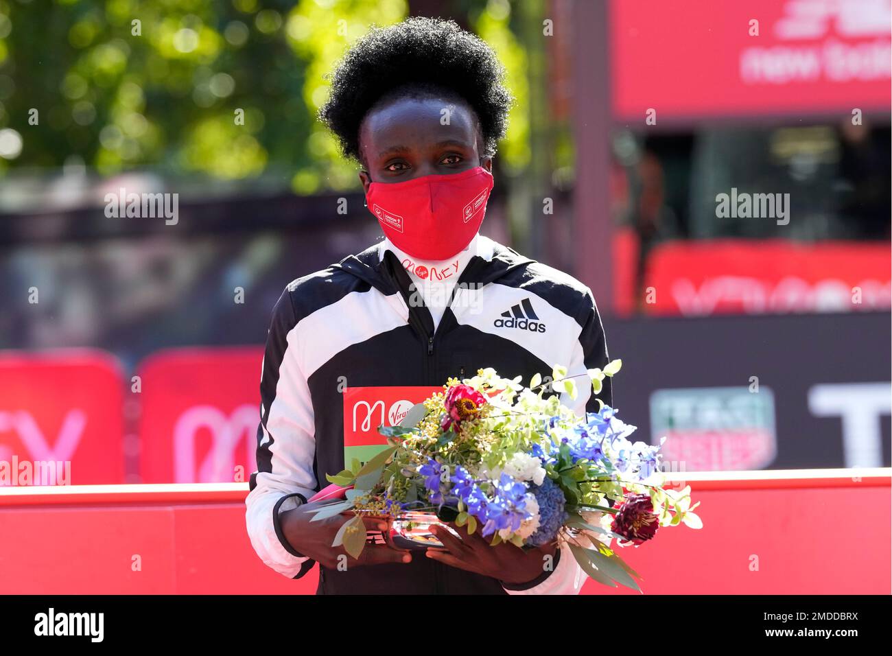 Kenya's Joyciline Jepkosgei poses with flowers and her trophy after ...