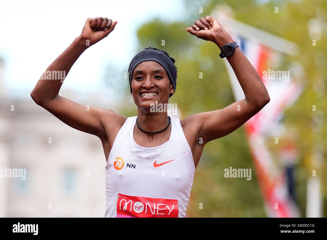 Ethiopia's Degitu Azimeraw reacts after crossing the finish line to take second place in the ...
