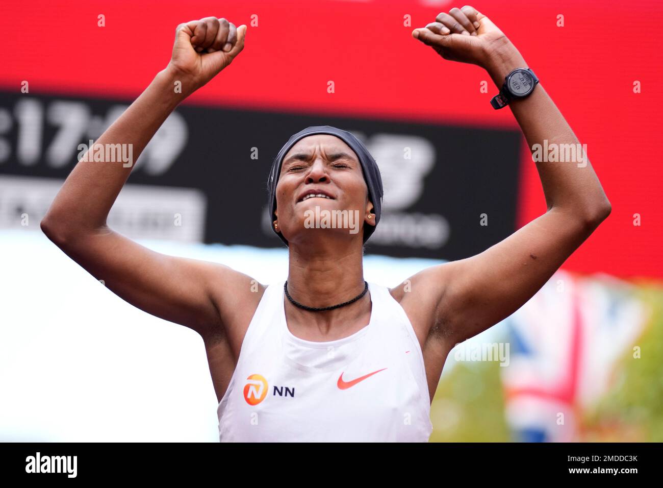 Ethiopia's Degitu Azimeraw reacts after crossing the finish line to take second place in the ...