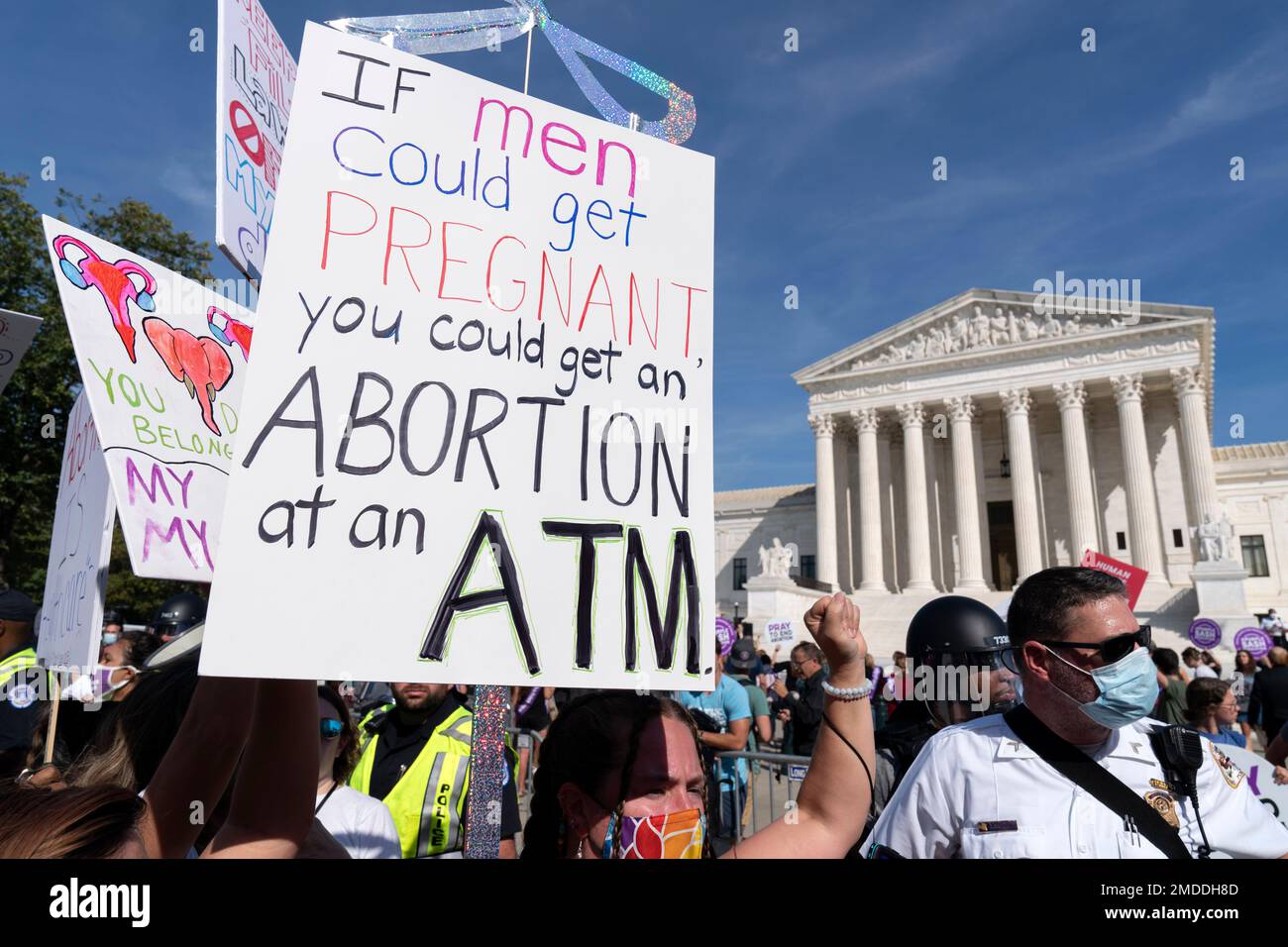 Demonstrators march outside of the the U.S. Supreme Court during the ...