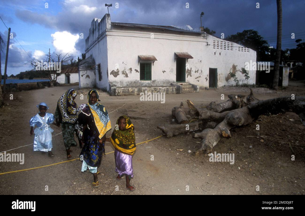 Children wearing new clothes pass a mosque in Mikindani, eid-ul-fitr ...